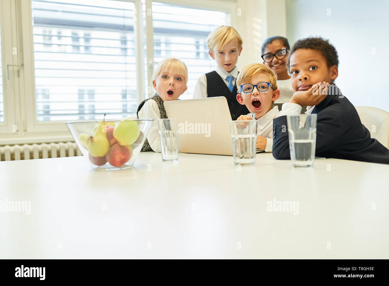Children as business people or students in a computer class at the ...