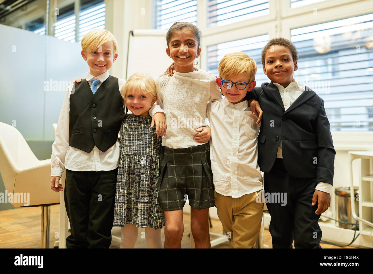 Group of multicultural kids as friends together make up a business team ...