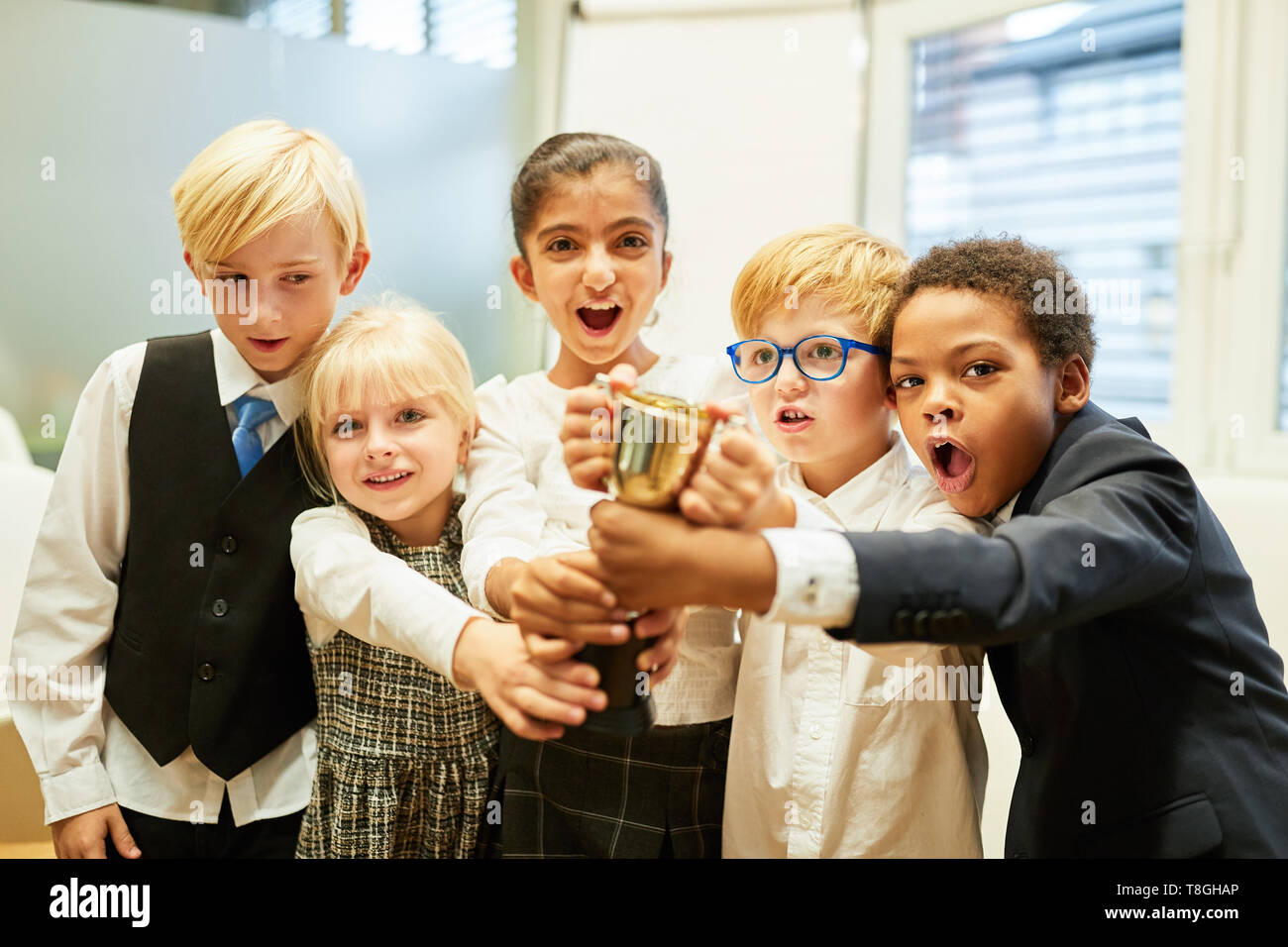 Successful cheering kids as multicultural business team with winning ...