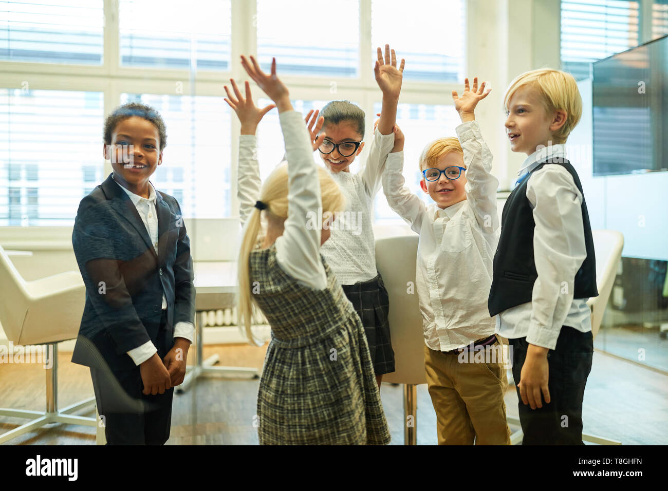 Multicultural Business Kids Team doing an exercise for team development ...