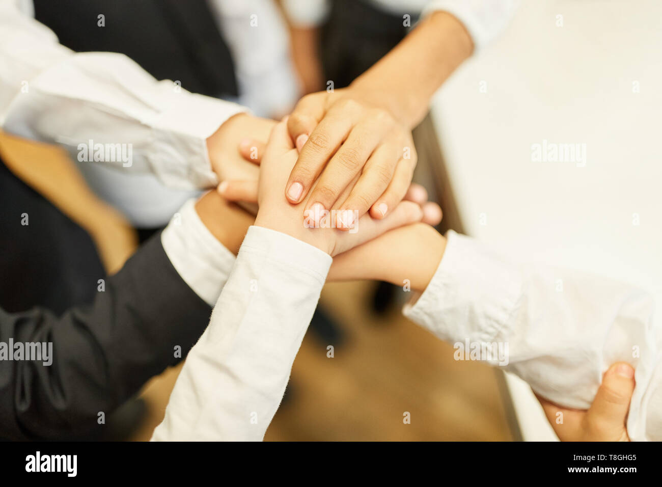 Business team stacking hands as exercise in teambuilding workshop Stock ...