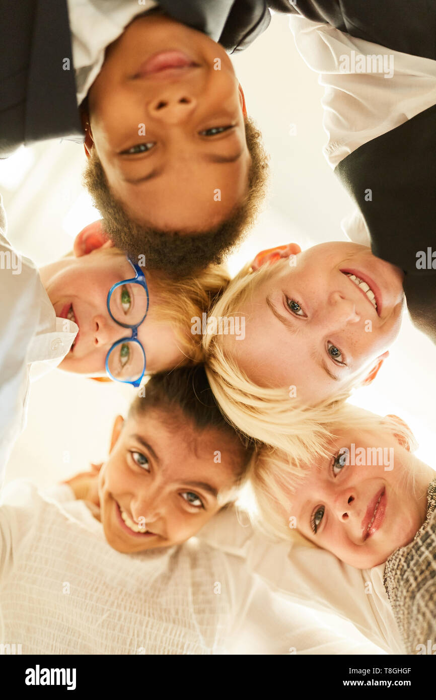 Group of happy kids as multicultural friends in circle for community ...