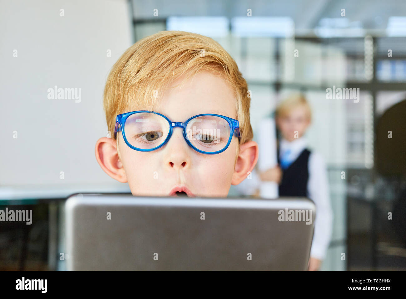 Child as a programmer or software developer and nerd at the computer ...