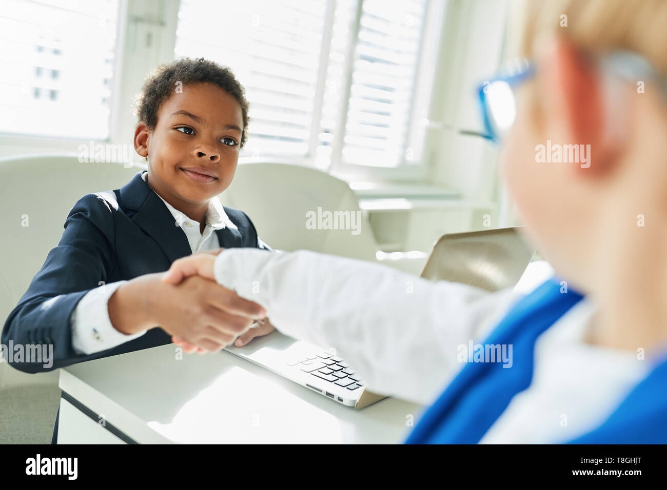 Two children as business partners at the handshake for greeting or at ...