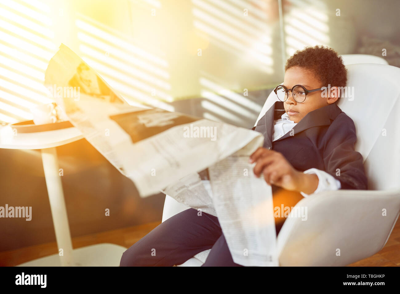 Child reading newspaper hi-res stock photography and images - Alamy