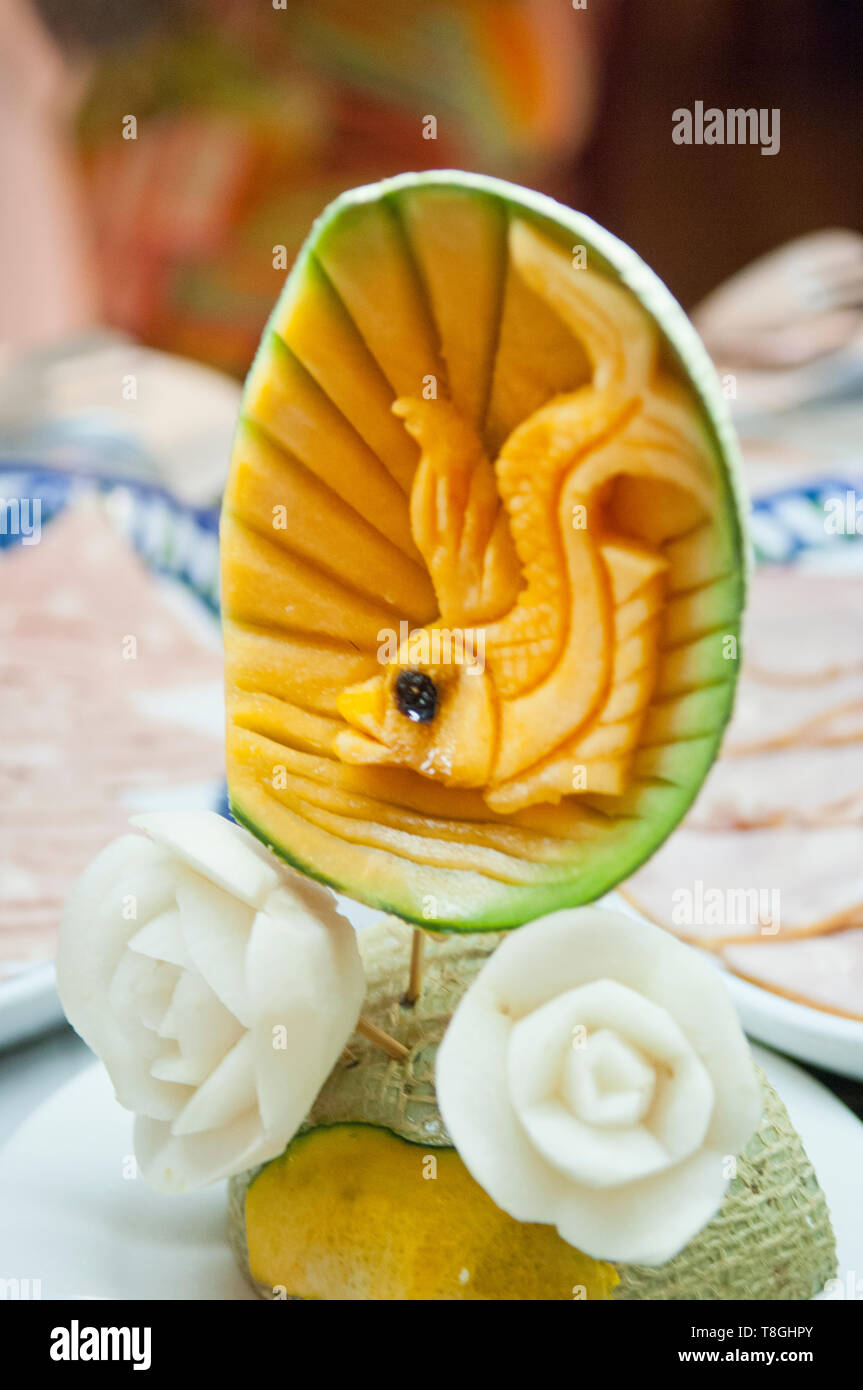 Carved melons decorate table at a buffet restaurant in Negril, Jamaica ...