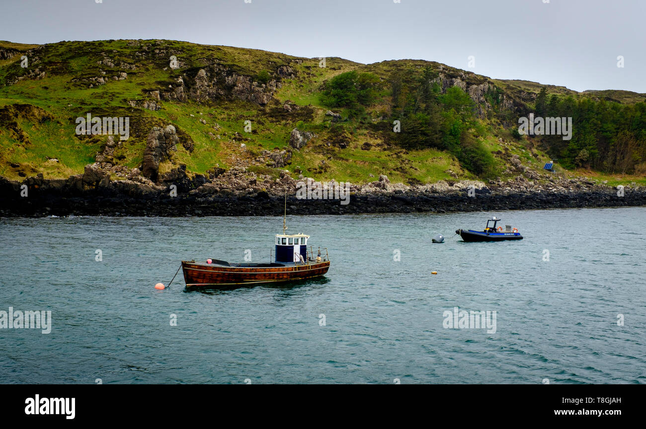 Small boats anchored of the island of Muck on the west coast of ...
