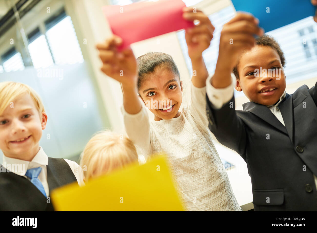 Business kids enjoy team building workshop with colorful paperwork ...