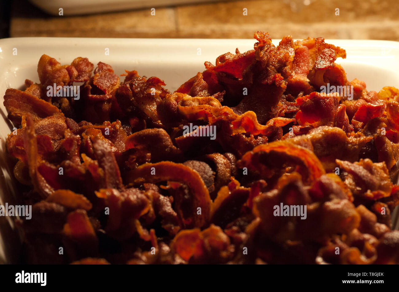 a Pile fried bacon in a dish at a buffet breakfast Stock Photo - Alamy