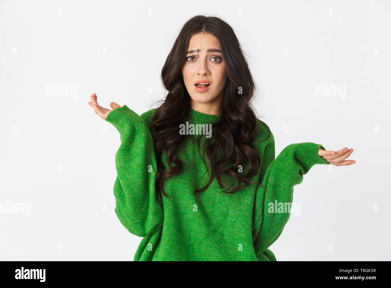 Image of beautiful confused scared young woman dressed in green sweater ...