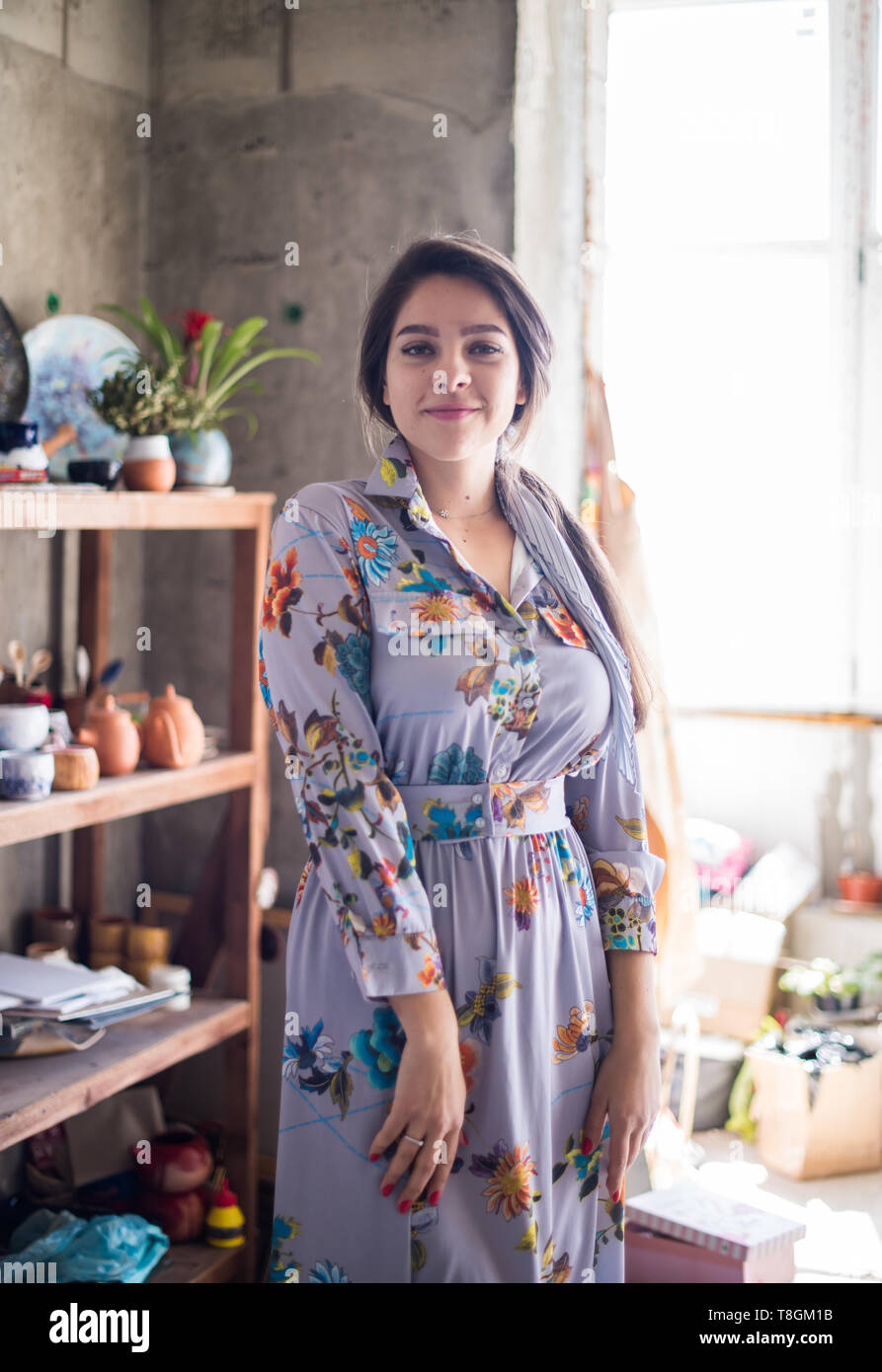 Beautiful lady artist standing in her studio, creative business owner ...