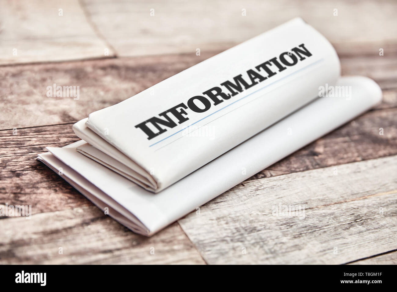 Information on newspaper or newsletter folded on a table Stock Photo ...