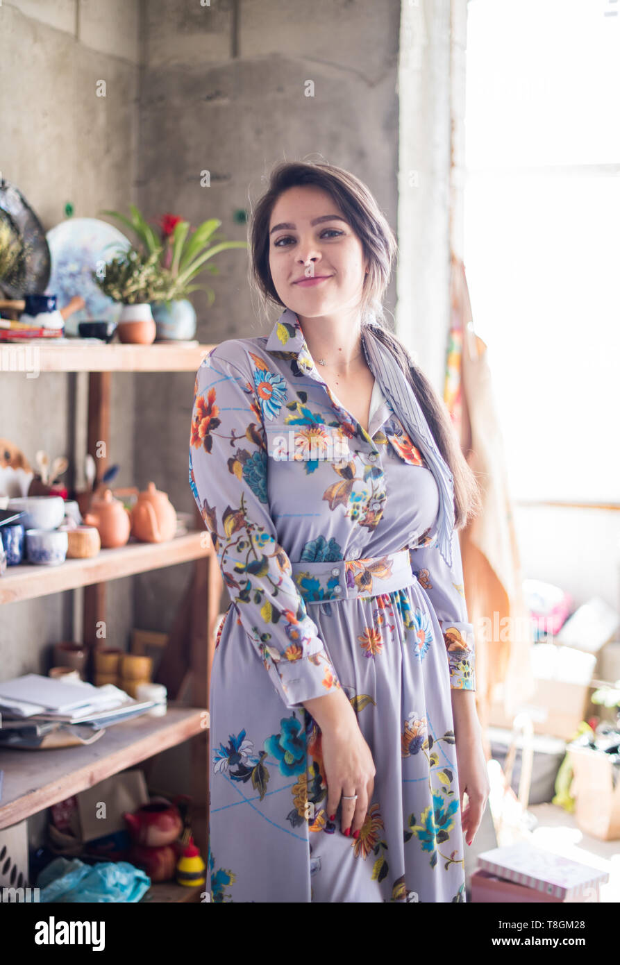 Beautiful lady artist standing in her studio, creative business owner ...