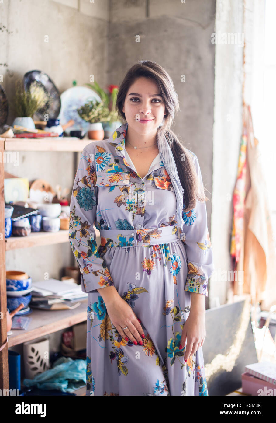 Beautiful lady artist standing in her studio, creative business owner ...