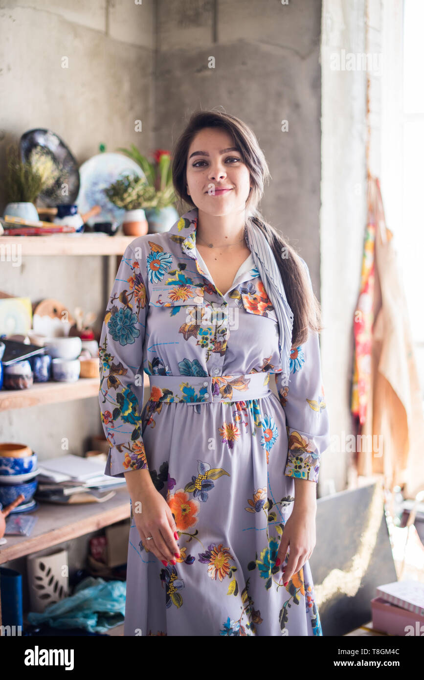 Beautiful lady artist standing in her studio, creative business owner ...