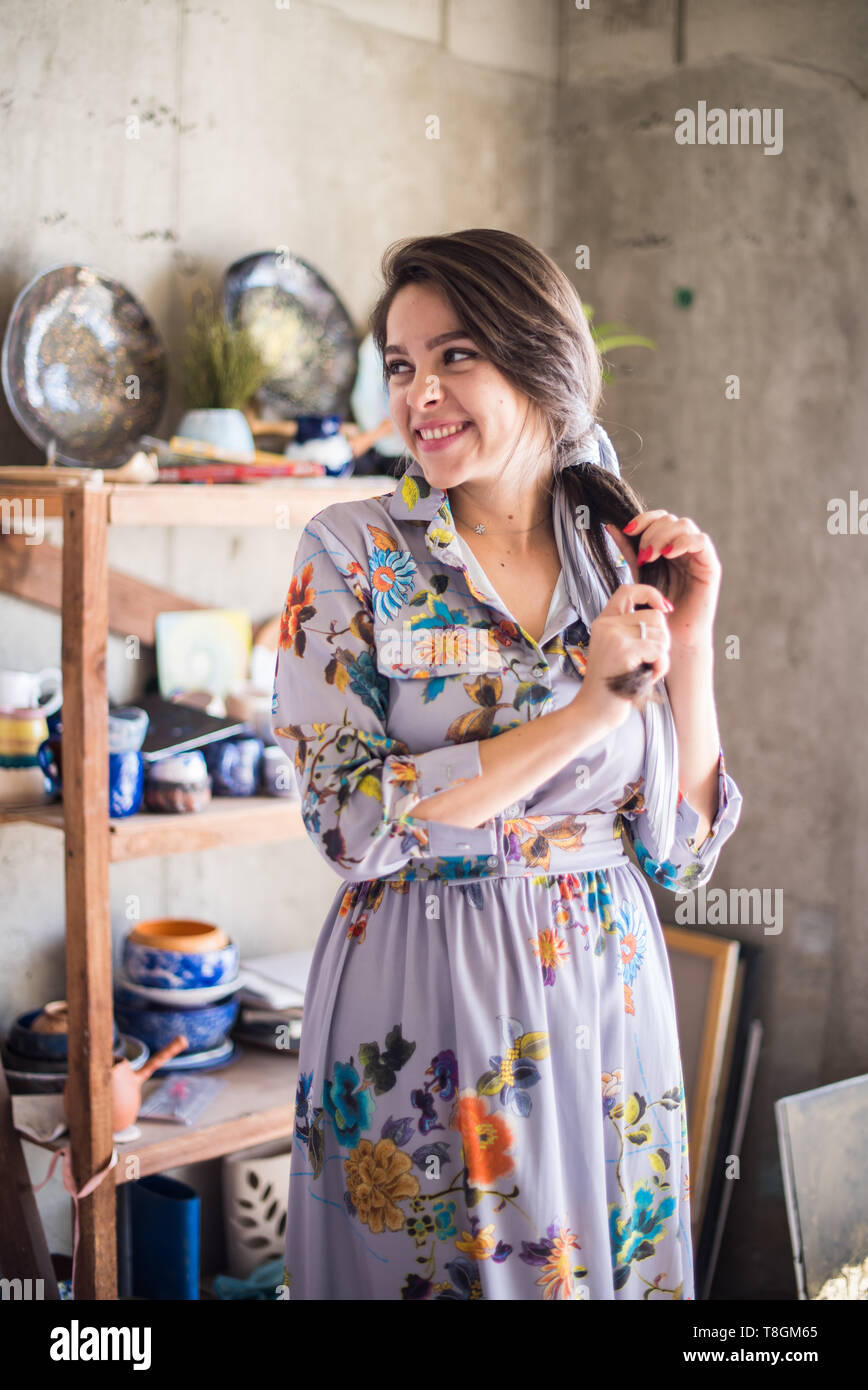 Beautiful lady artist standing in her studio, creative business owner ...
