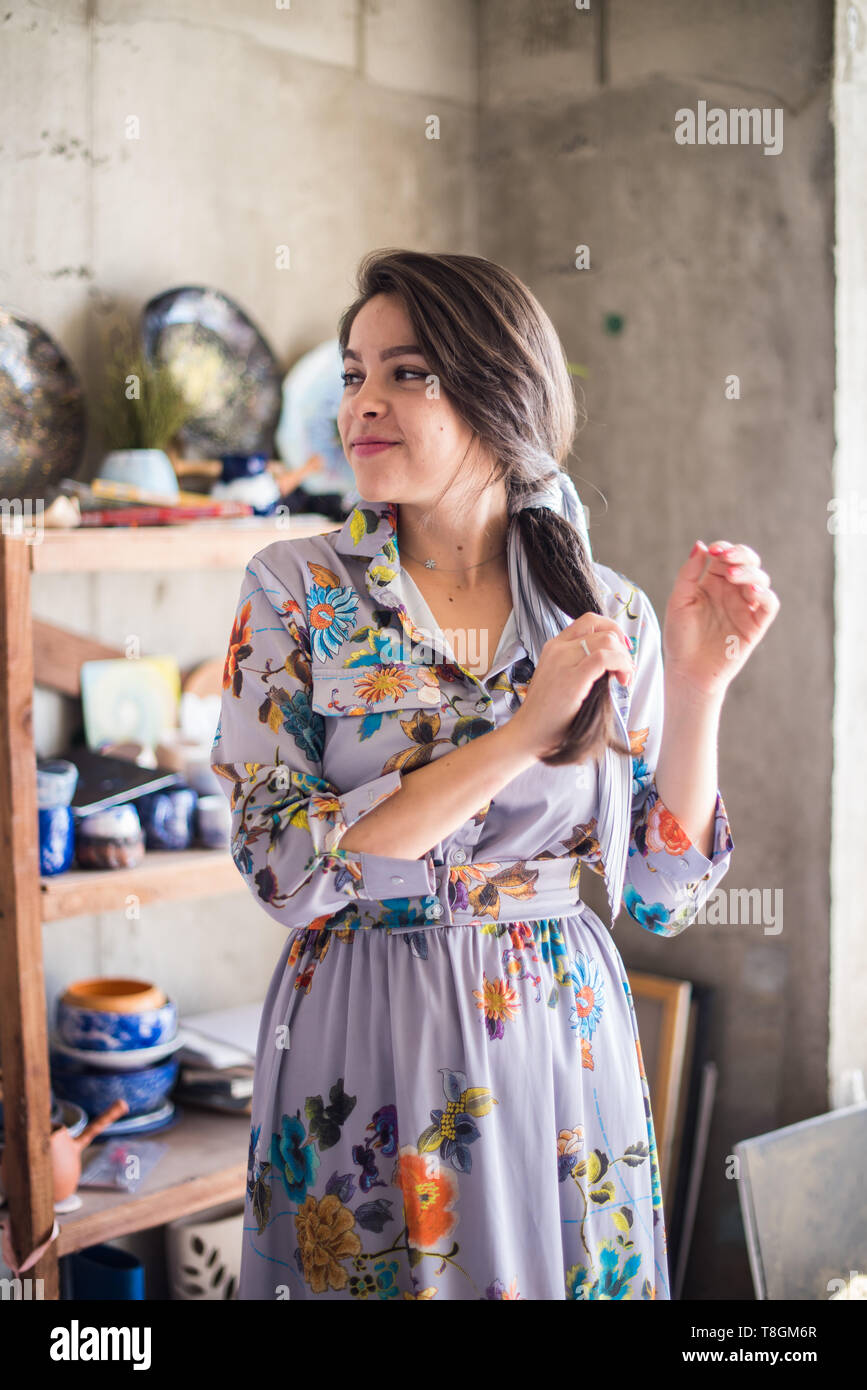 Beautiful lady artist standing in her studio, creative business owner ...