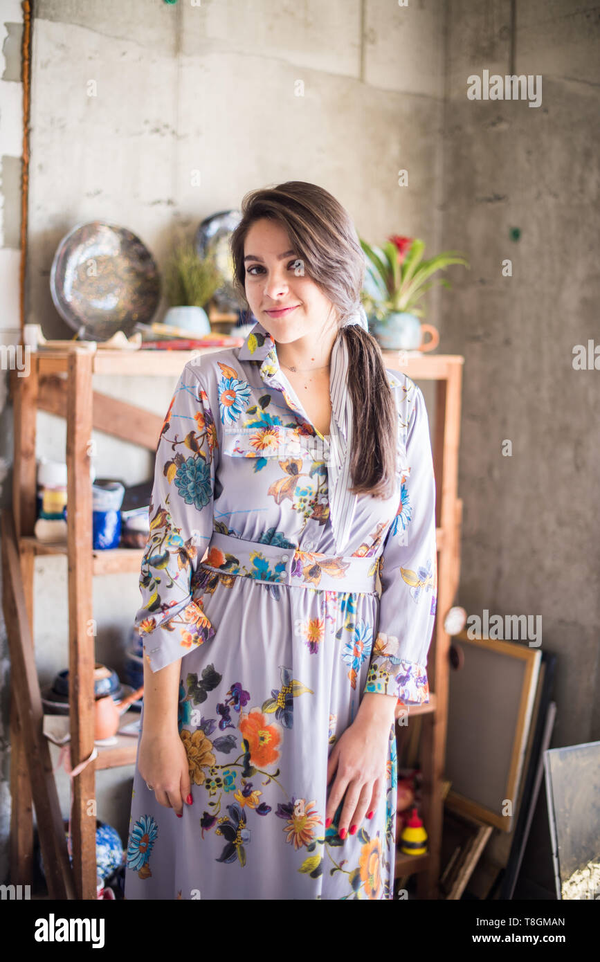 Beautiful lady artist standing in her studio, creative business owner ...