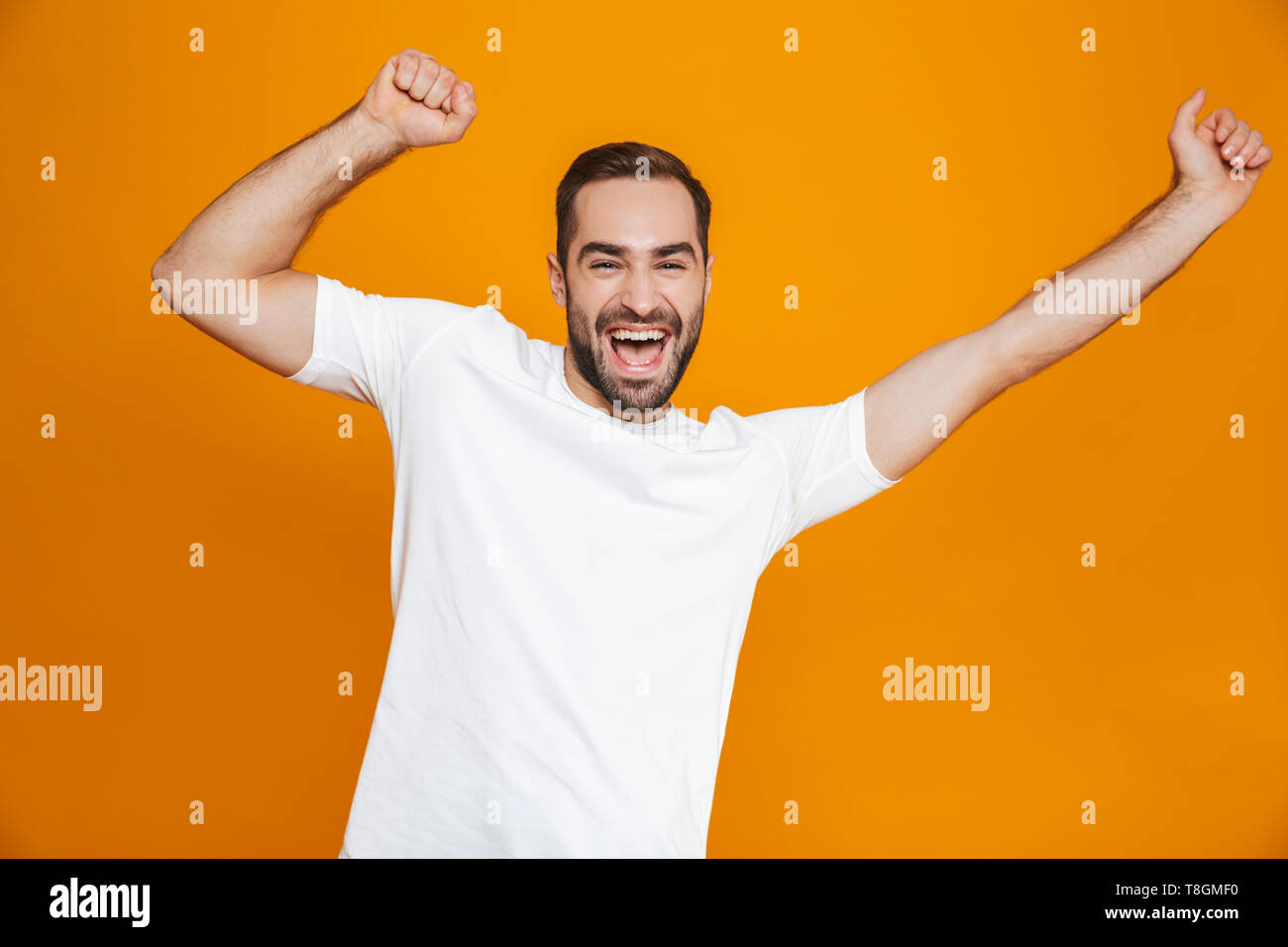 Image of excited man 30s with beard and mustache smiling while standing ...