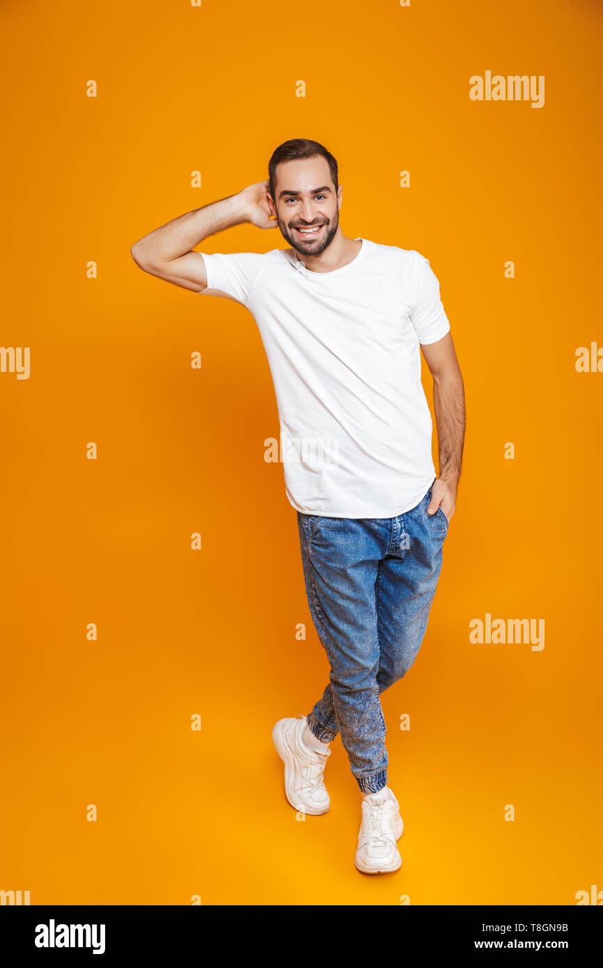 Full length image of attractive man 30s with beard and mustache smiling ...