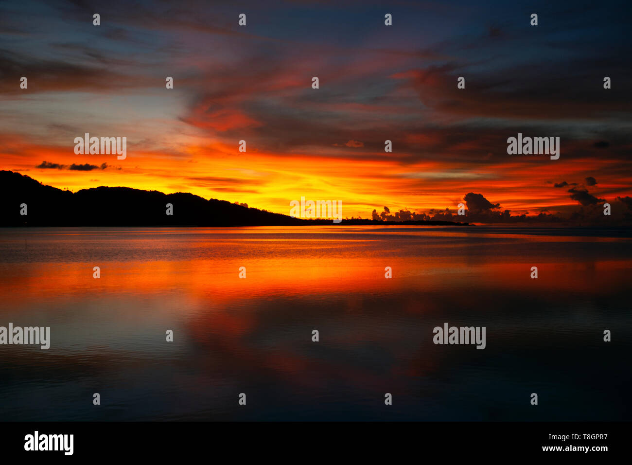 Golden sky with clouds at sunset, U district, Pohnpei, Federated States ...