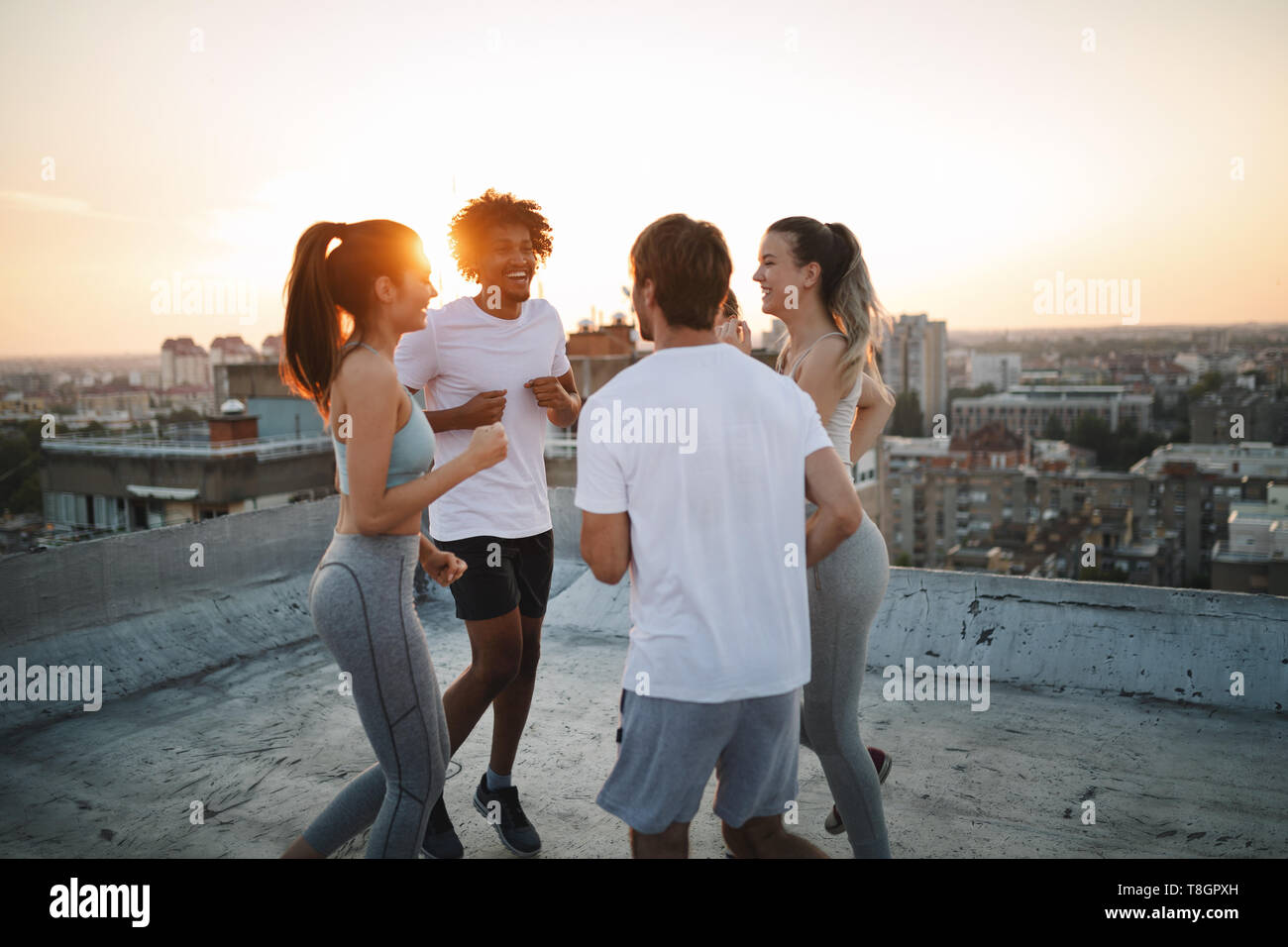 Group of fit healthy friends, people exercising together outdoor on ...
