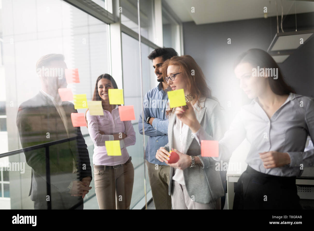 Business people meeting at office and use post it notes to share idea ...