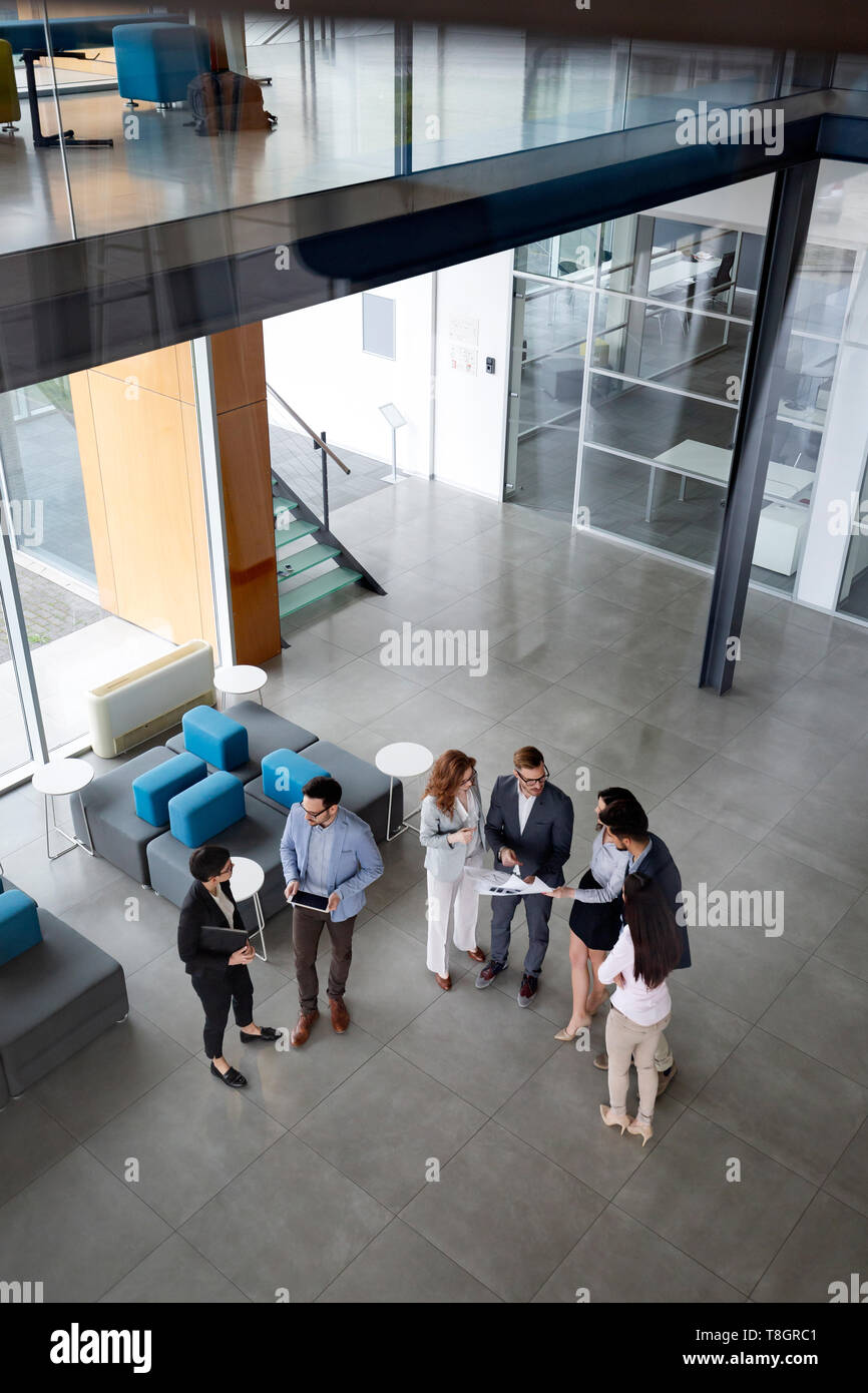 Business people working together in office hall Stock Photo - Alamy