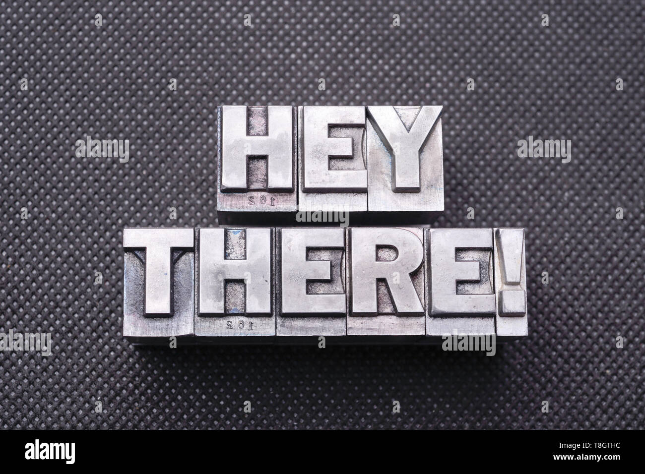 hey there exclamation made from metallic letterpress blocks on black ...