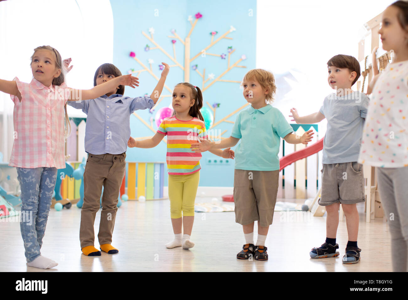 Preschool kids practicing gymnastics in kindergarten. Childhood and ...