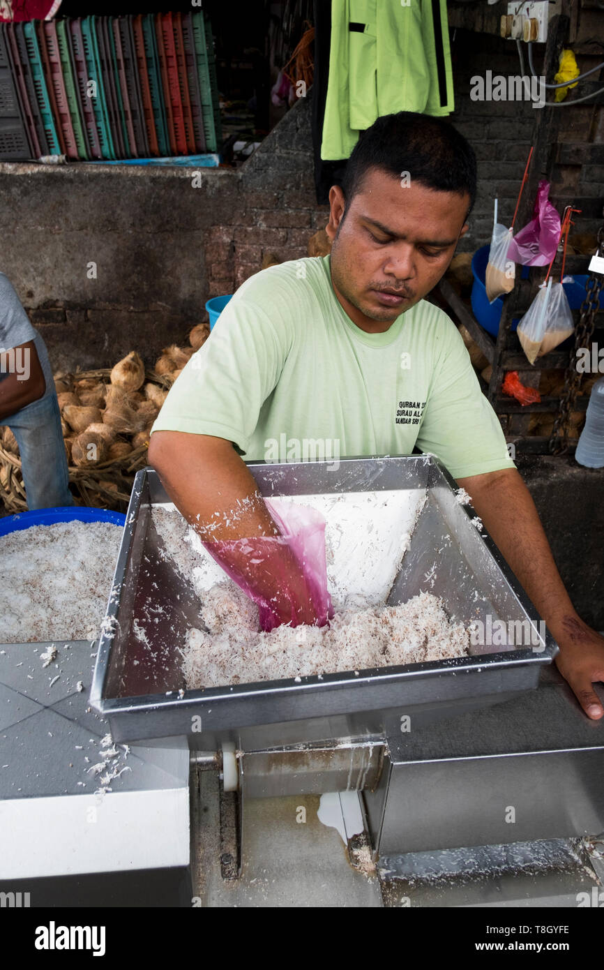 Making fresh coconut milk at a traditional market in Kuala Lumpur ...