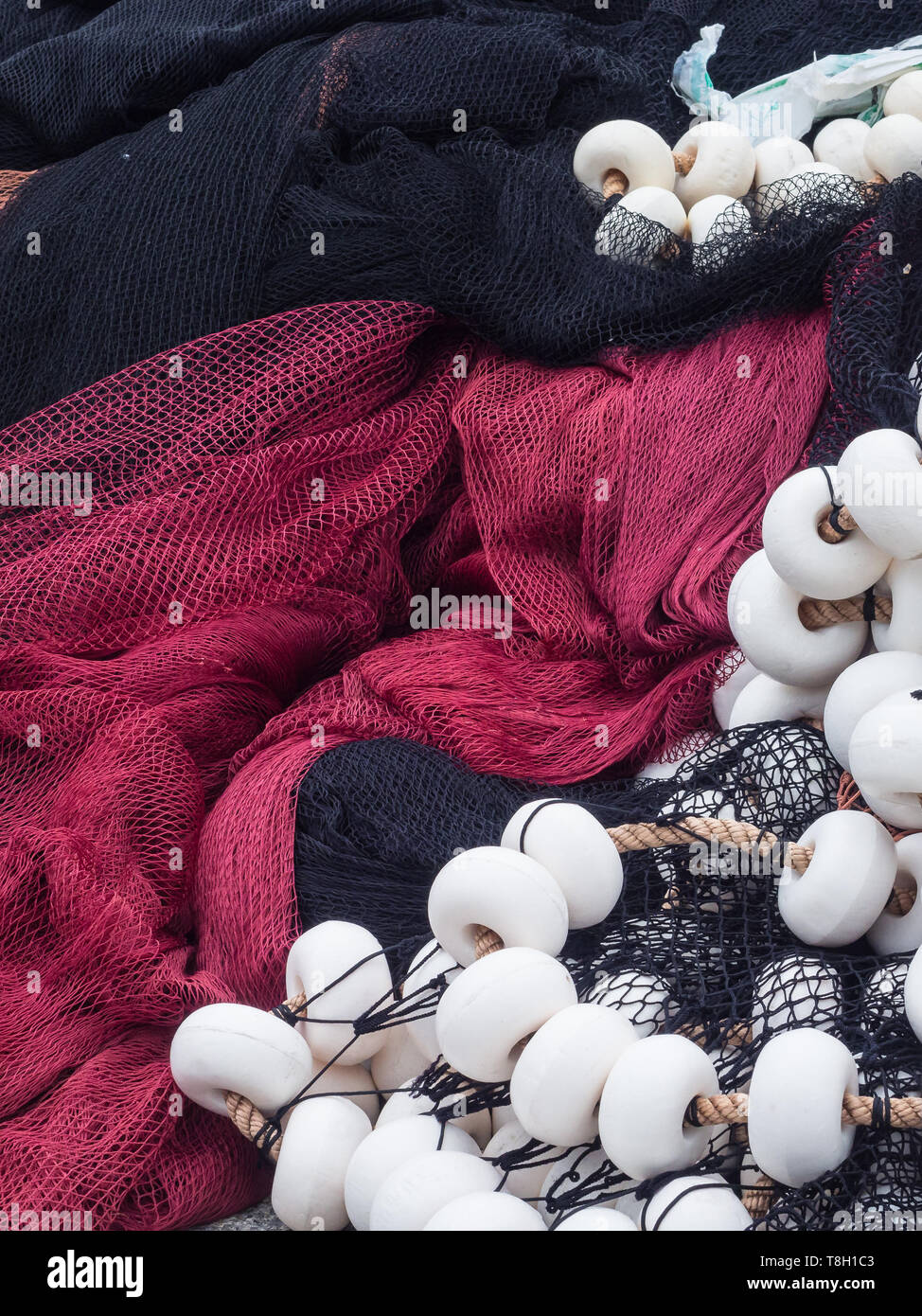 Detail of black and red fishing nets with white floats. traditional ...