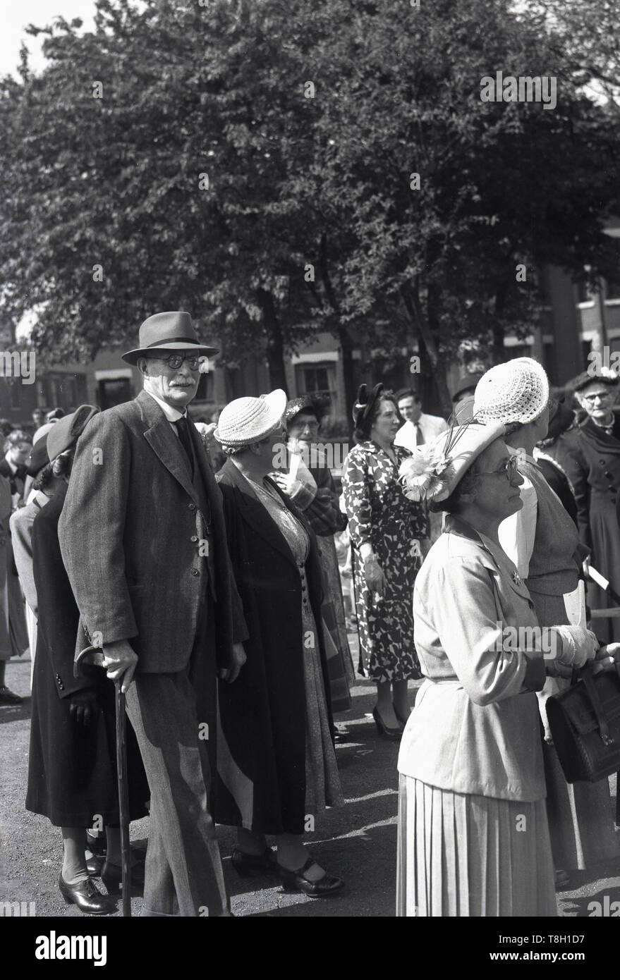 1950s, historical, local elderly people, well-dressed, taking part in ...