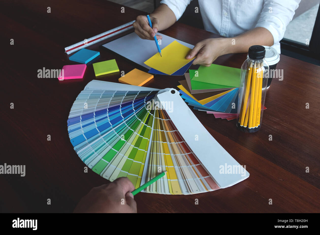 Graphic designer choose colors from the color bands samples for design ...