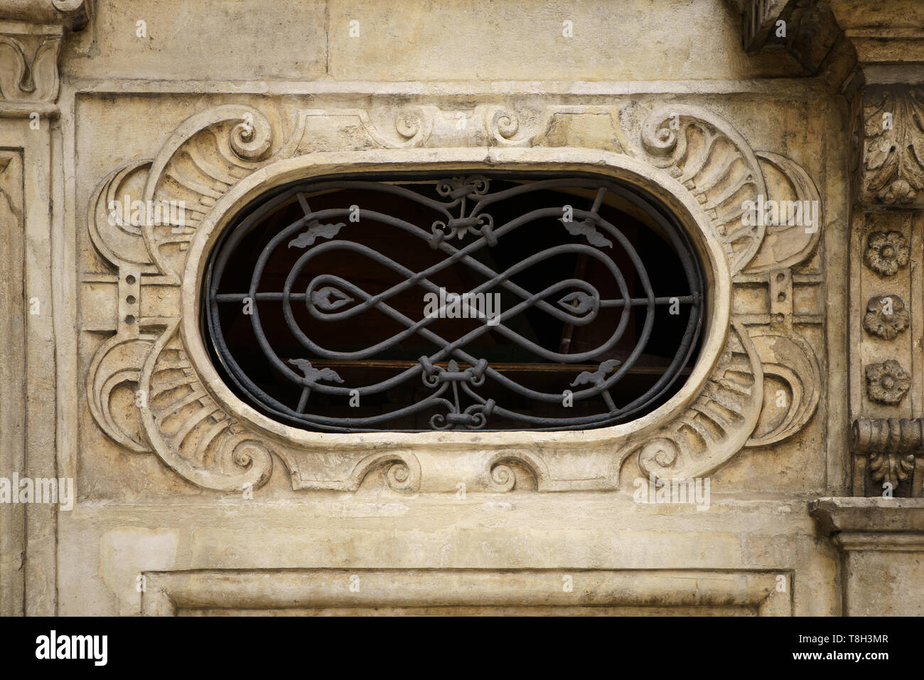 Ancient metal window frame on weather old building wall in old European ...