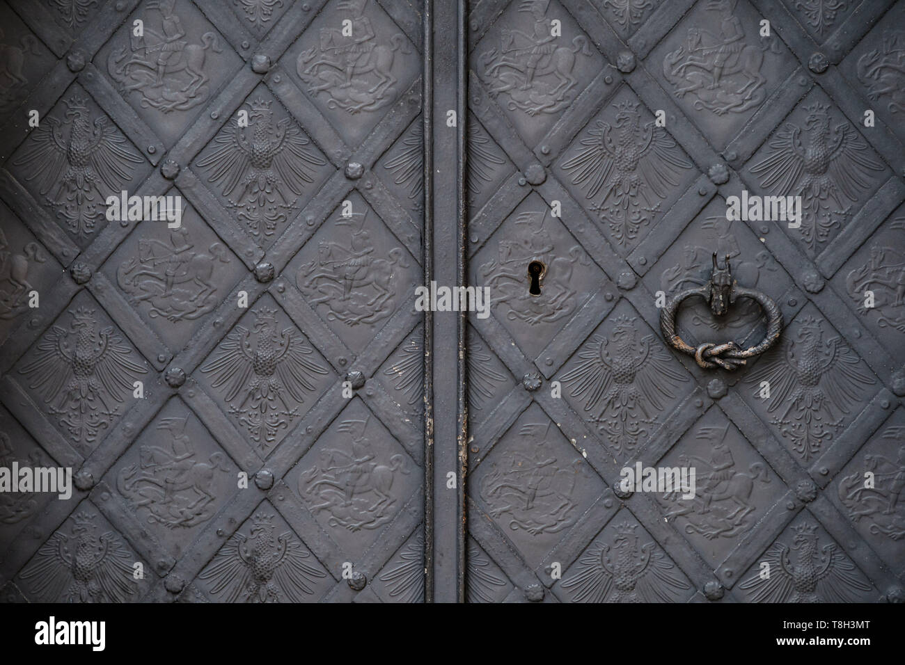 Ancient forged metal door in close up.Old christian church entrance in ...