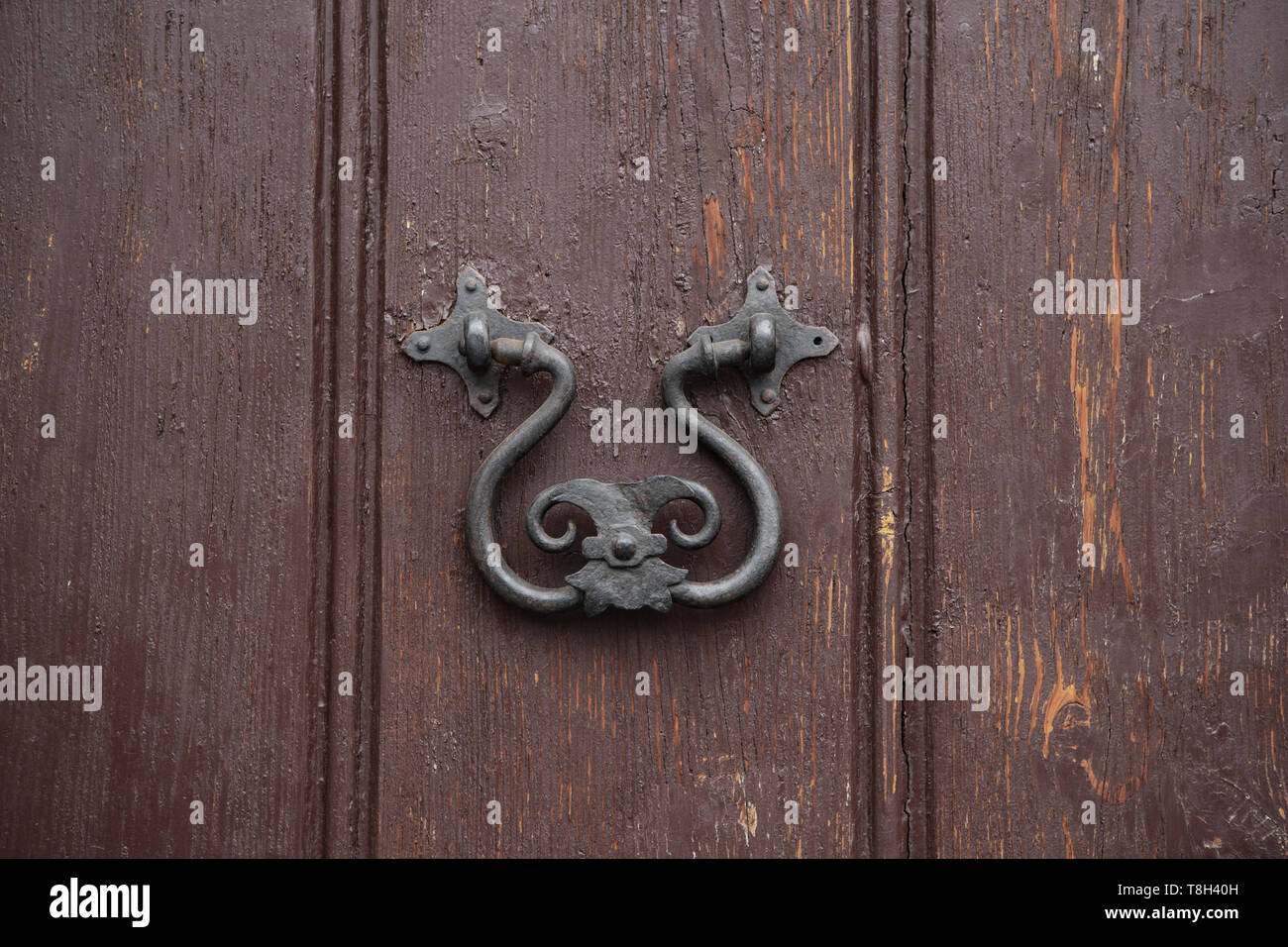 Vintage weathered door with decorative metal handle in close up.Ancient ...