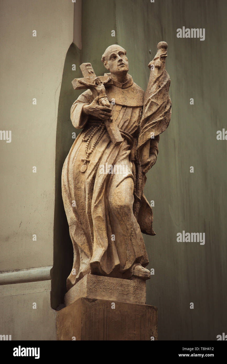 KRAKOW,POLAND-23 APRIL,2019: Ancient catholic statue of priest holding ...