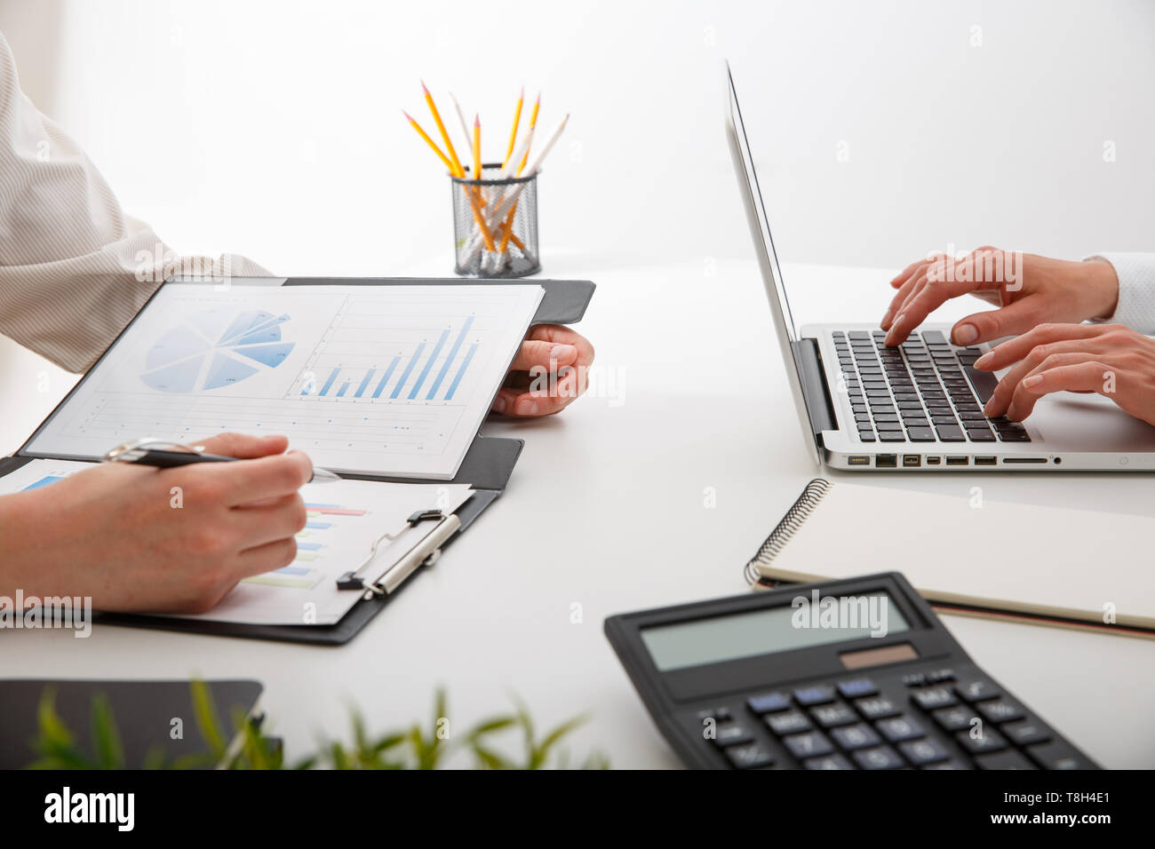 Business team two colleagues discussing new plan financial graph data ...