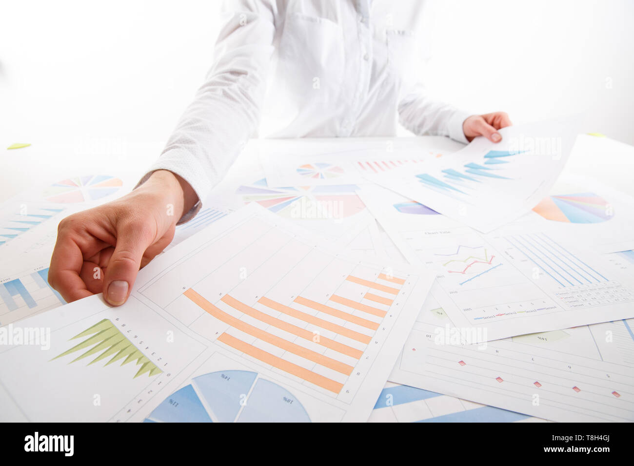 Business woman pointing at graph document close-up Stock Photo - Alamy