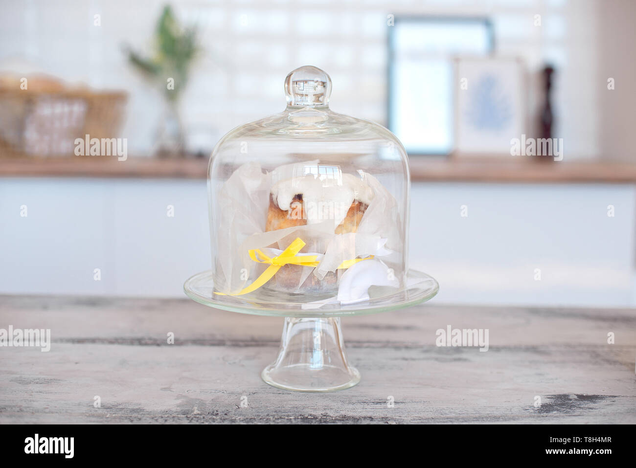 Glass cap for the cake stand is on a white table in a bright room Stock ...