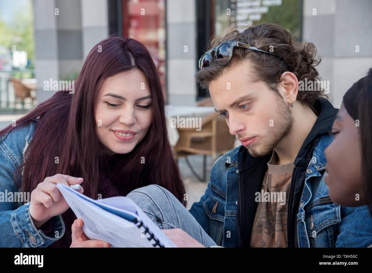 group of multi-ethnic students waiting and studying on the bench Stock ...