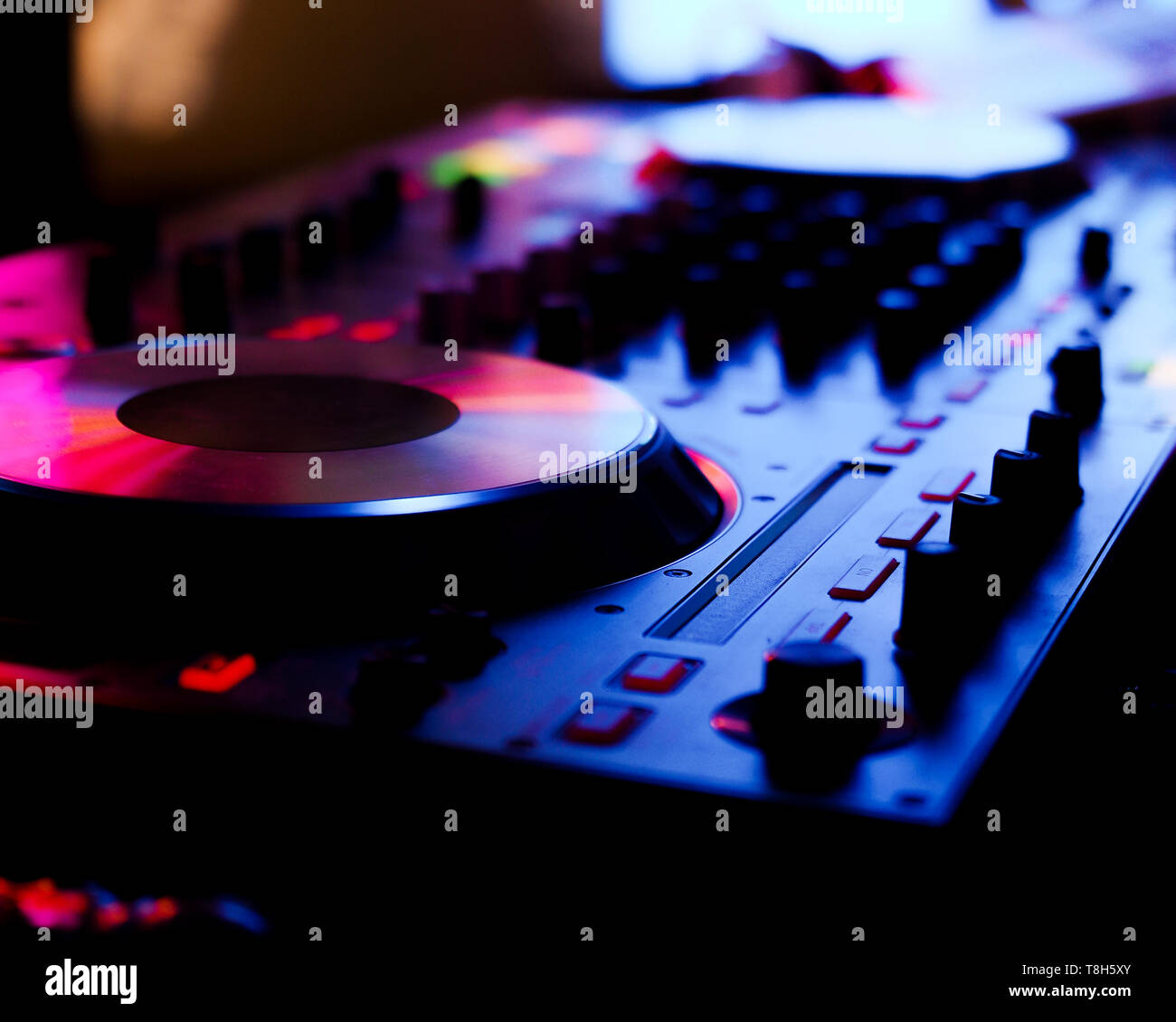 DJ controller audio mixer neon light night club Stock Photo - Alamy