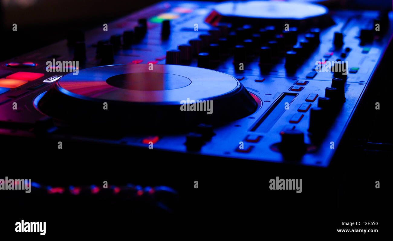 DJ controller audio mixer neon light night club Stock Photo - Alamy