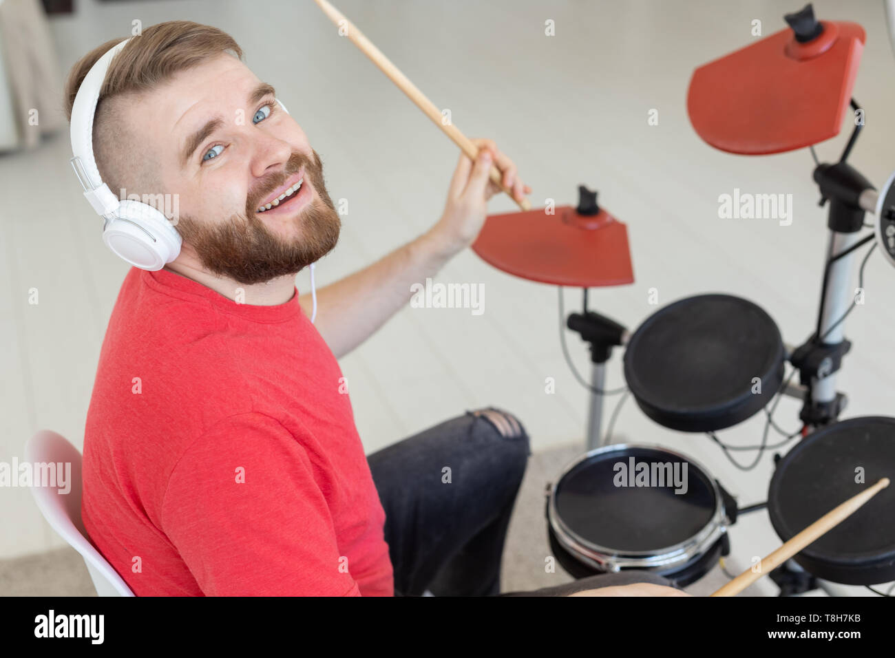 Music, hobby and people concept - Bearded drummer on a white room ...