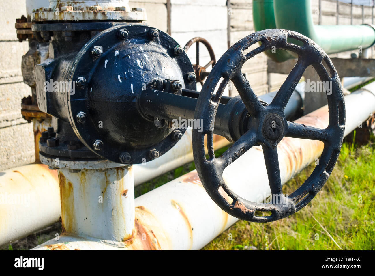 Big pipe tap on gas pipes network Stock Photo - Alamy
