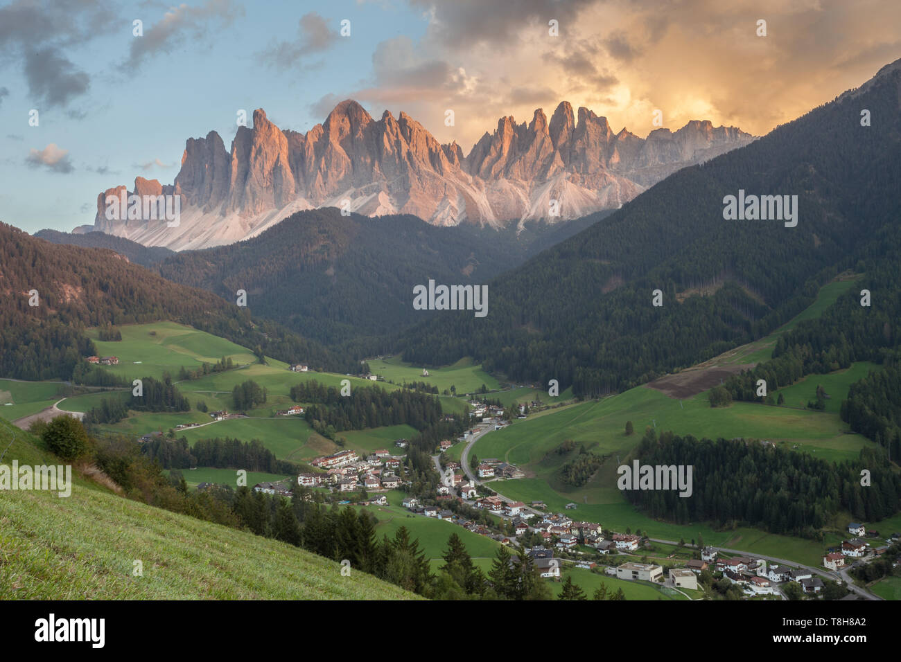 Small Italian mountain town of St. Magdalena in Val di Funes at sunset ...