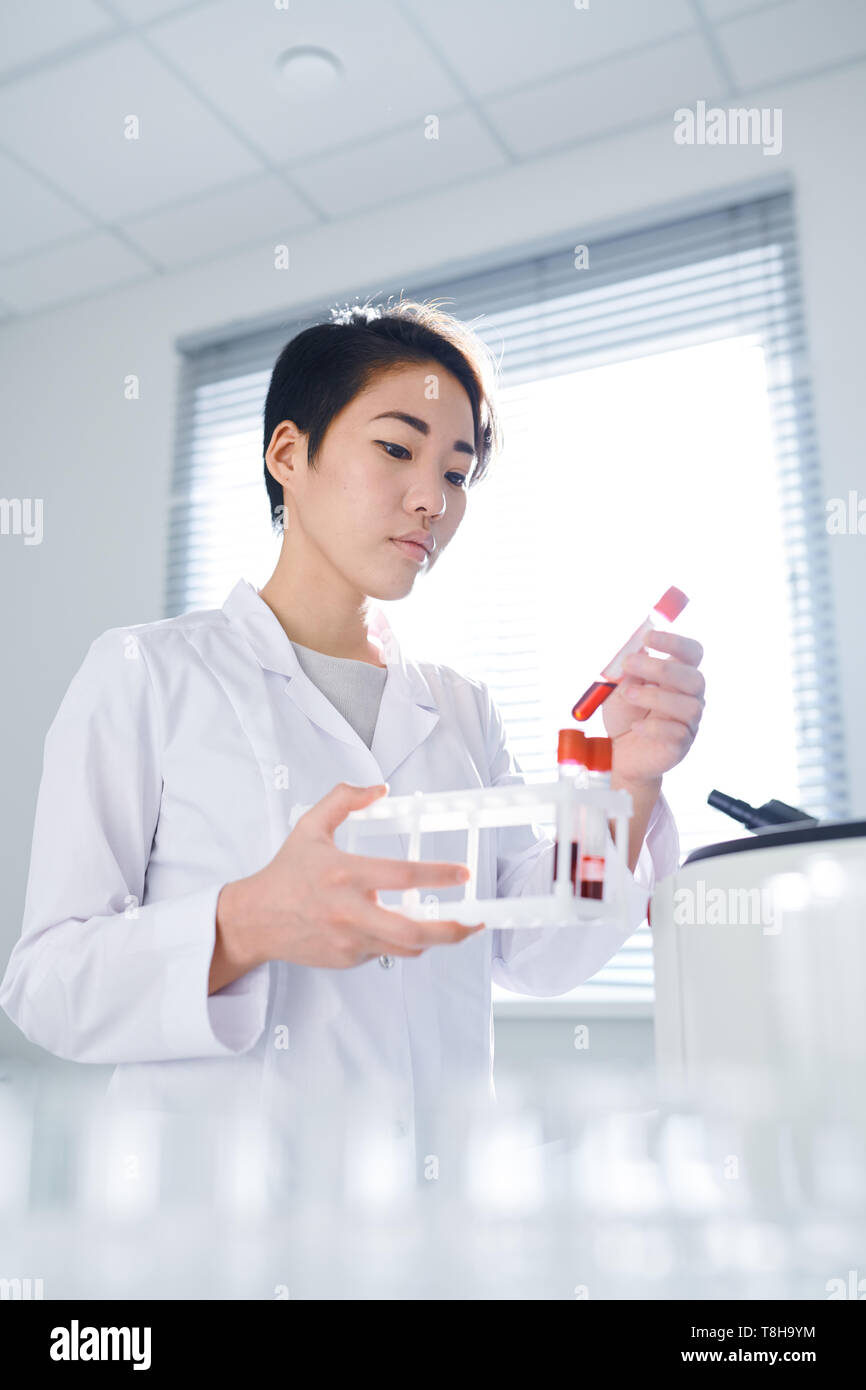 Examining blood sample in lab Stock Photo - Alamy