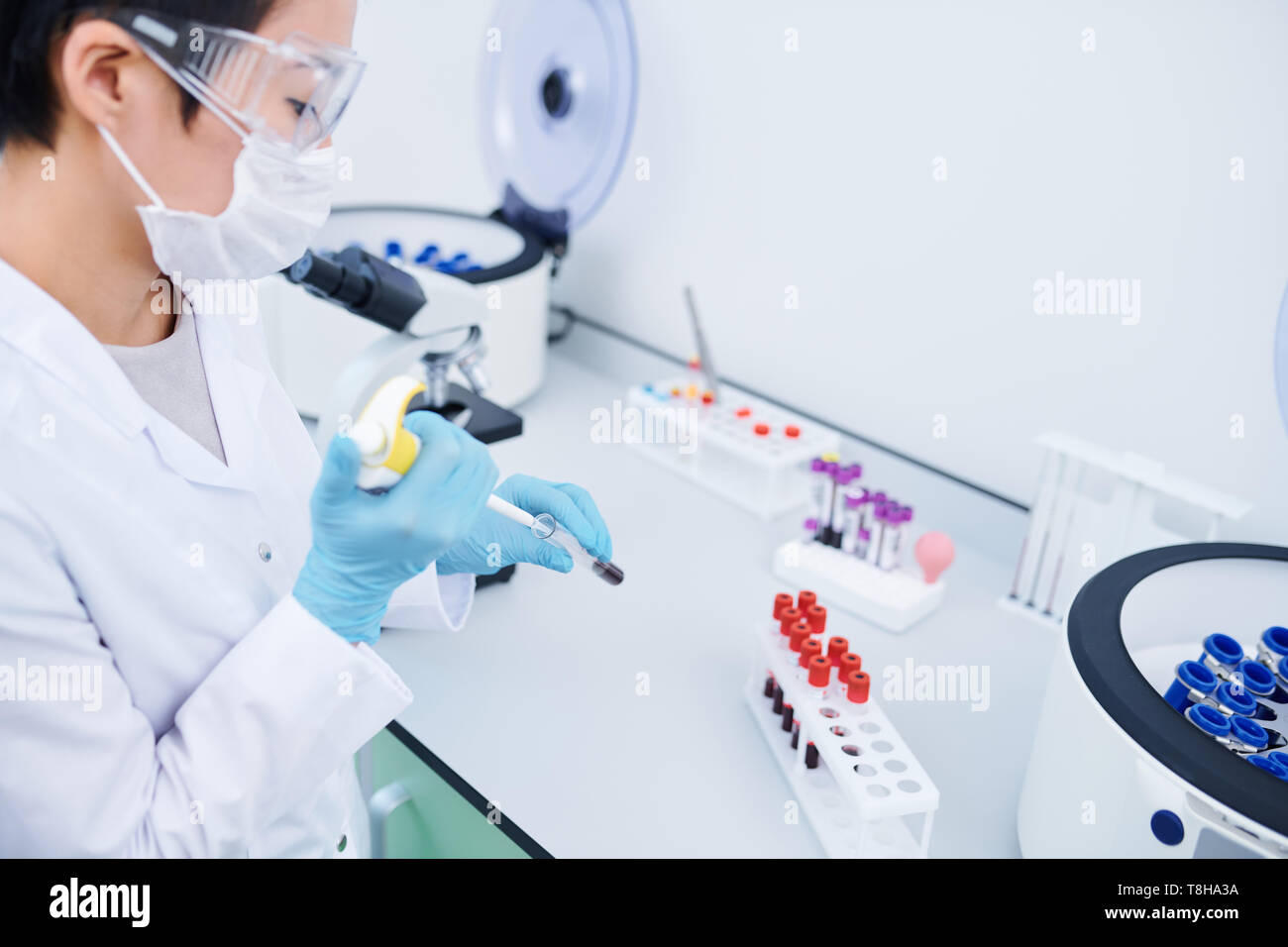 Busy laboratory worker adding blood in test tube Stock Photo - Alamy