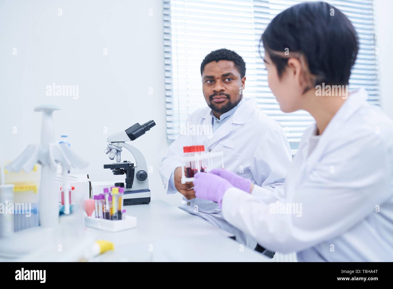Laboratory workers investigating samples Stock Photo - Alamy
